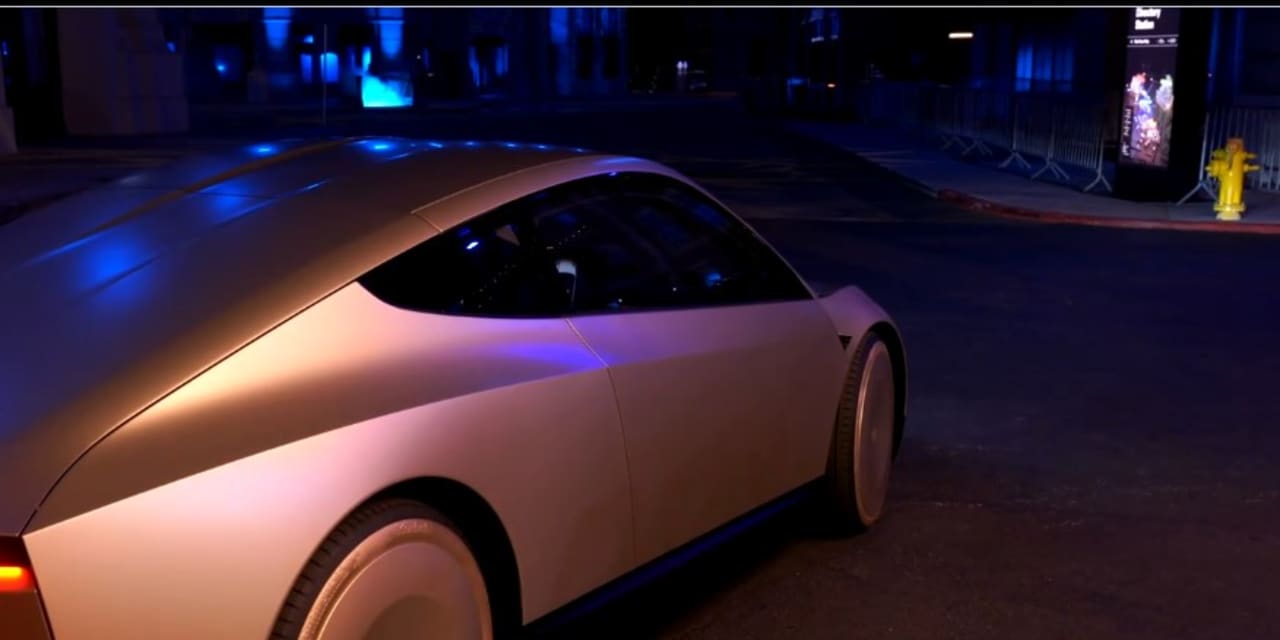 Tesla unveils its Cybercab robotaxi, with no steering wheel and under ...